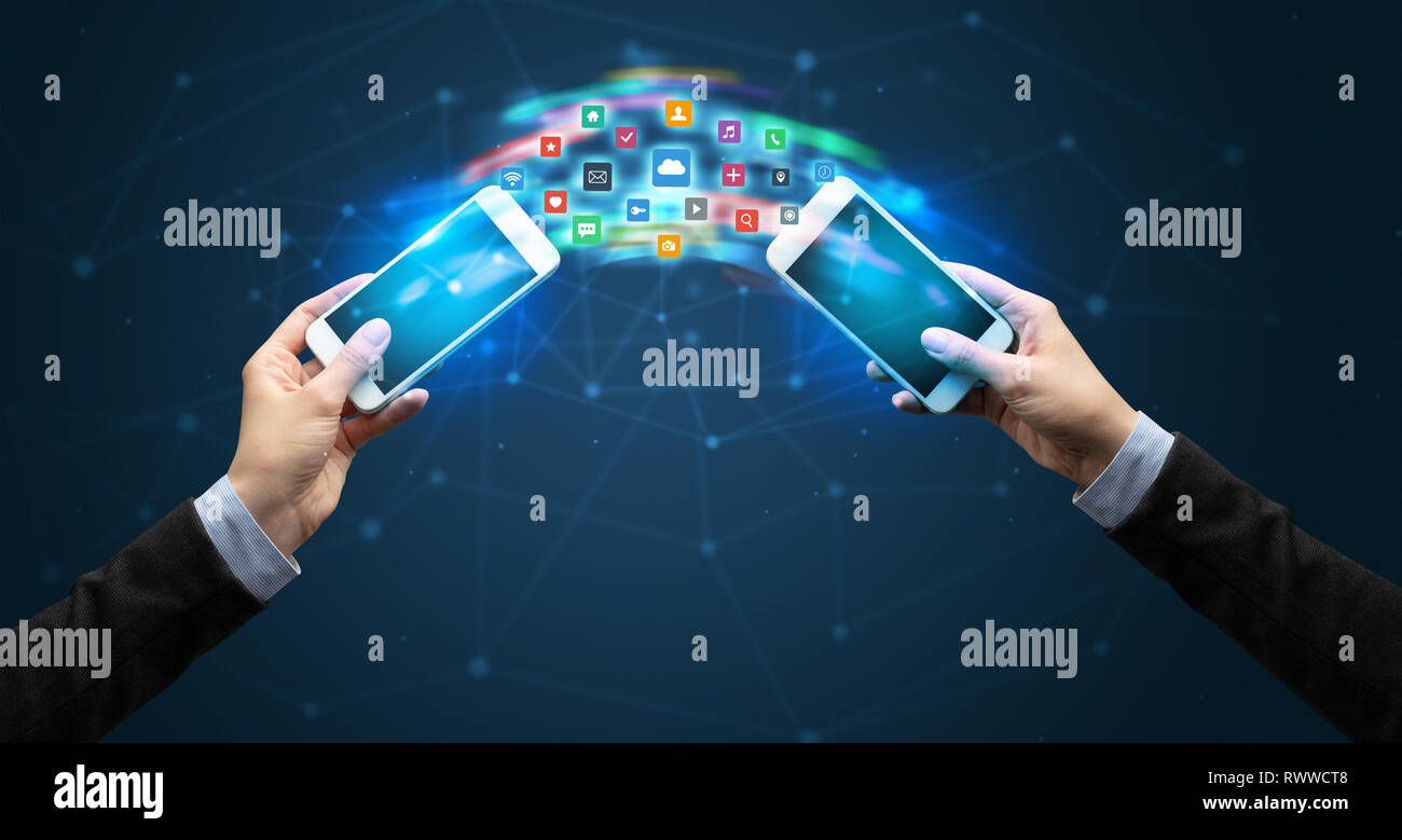 Two mobile phones syncing applications concept Stock Photo - Alamy