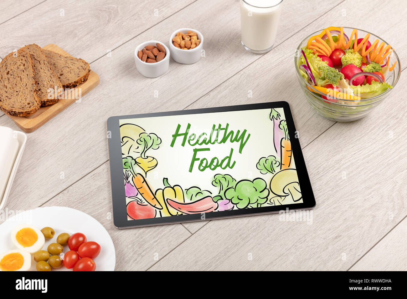 Healthy food composition with tablet Stock Photo - Alamy