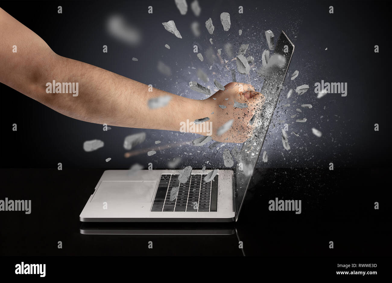 Strong male hand breaks laptop screen Stock Photo - Alamy