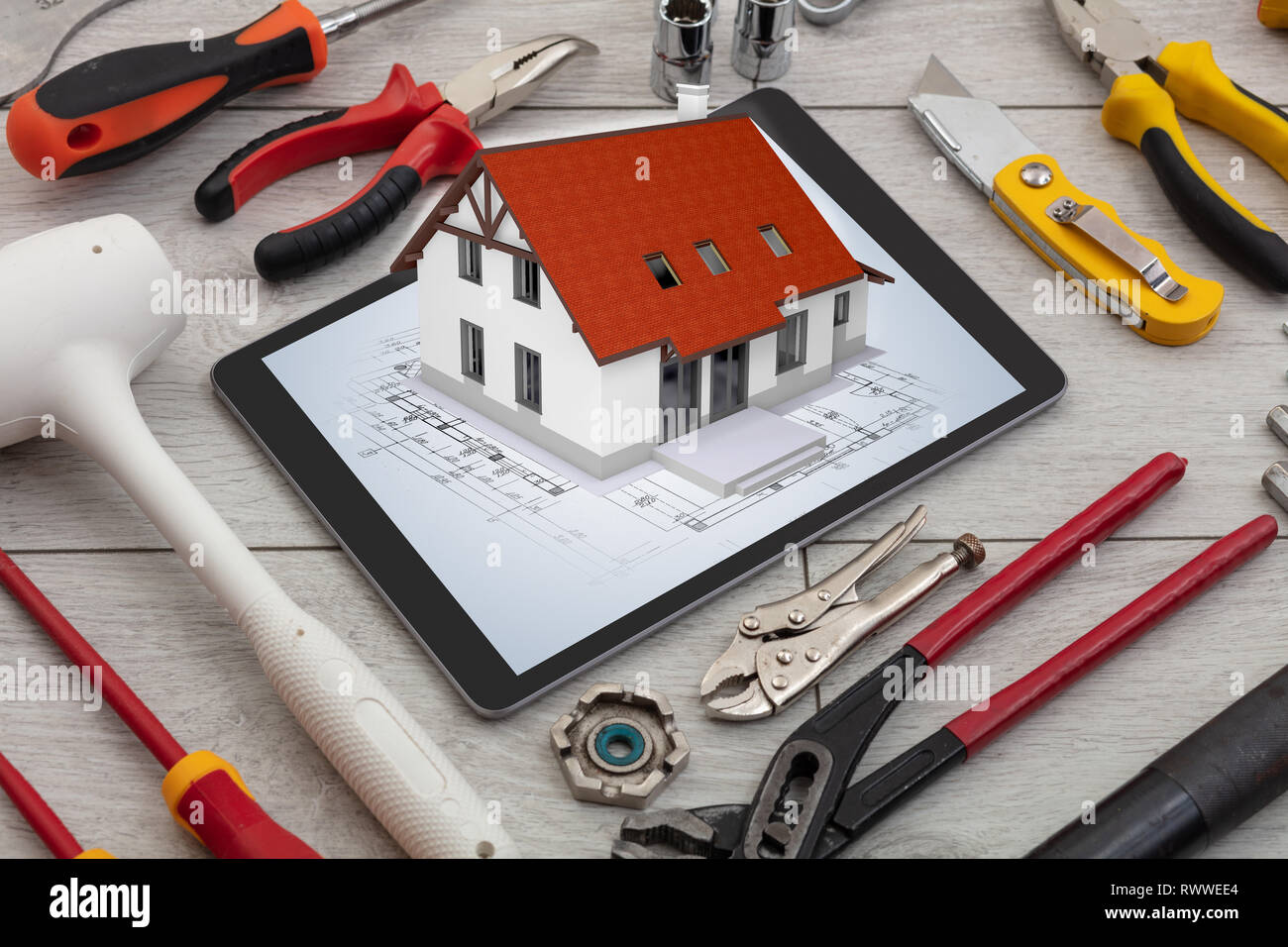 Tablet with construction tools and 3d home plan concept Stock Photo - Alamy