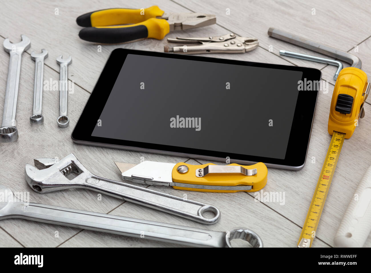 Tablet with empty screen and construction tools around Stock Photo - Alamy