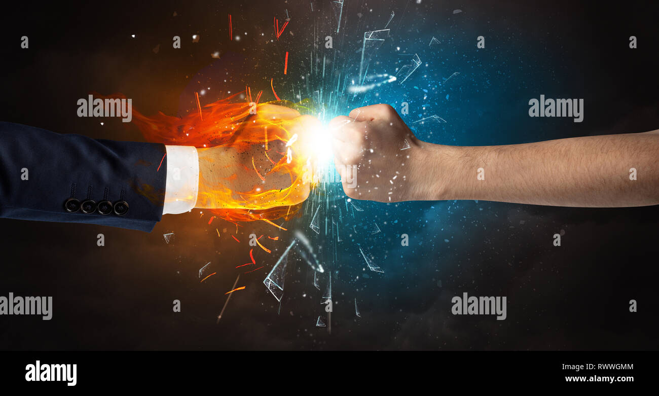 Two hands fighting and breaking glass into small pieces with fire and ...