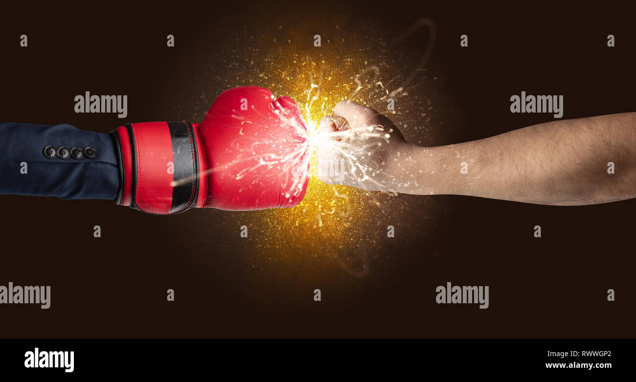 Two hands fighting with orange dust, spark, glow and smoke concept ...