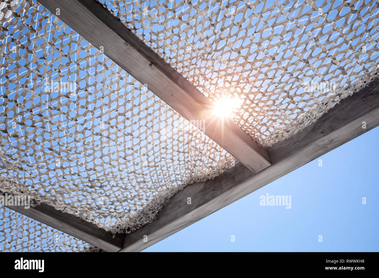 Sun canopy under blue sky with shining sun Stock Photo - Alamy