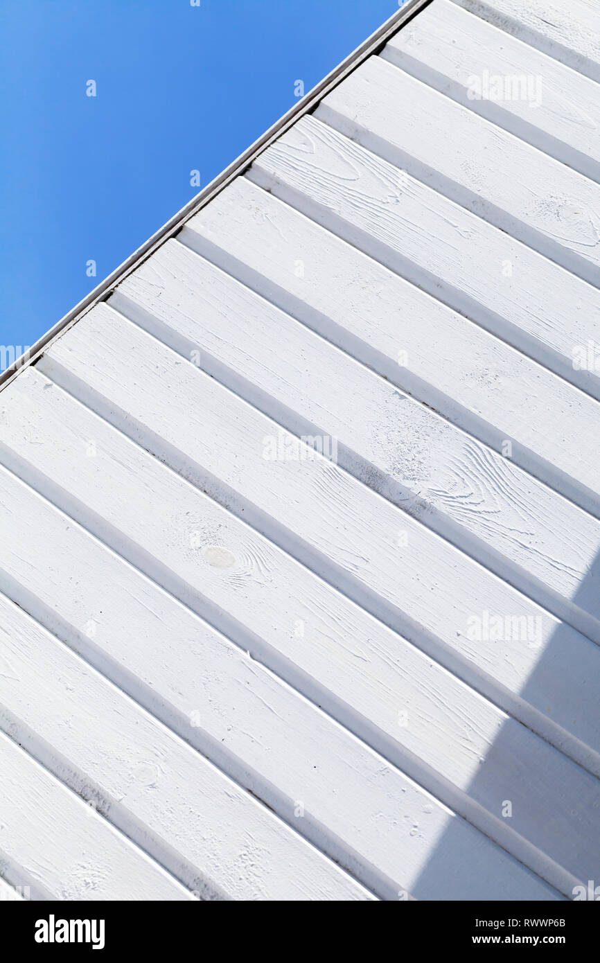 New white wooden wall with shadow area under blue sky, abstract ...