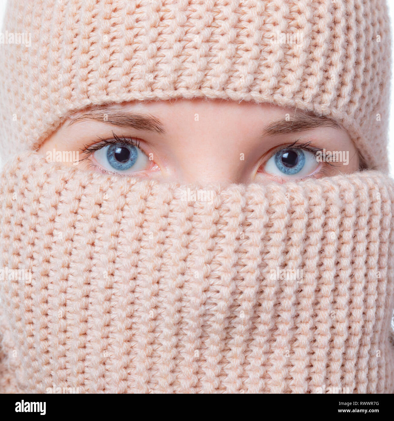 Close-up portrait of a girl with a hidden face, only a stare of blue ...