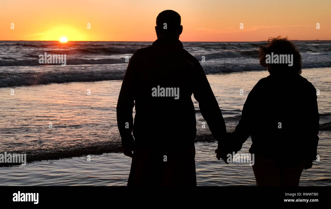 an old couple enjoying a lovely sunset at the beach Stock Photo - Alamy