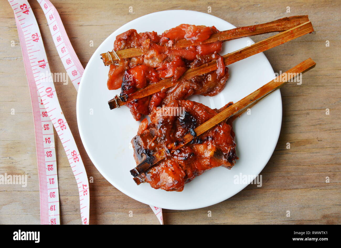 roasted chicken fat skin and measuring tape for check waistline after ...