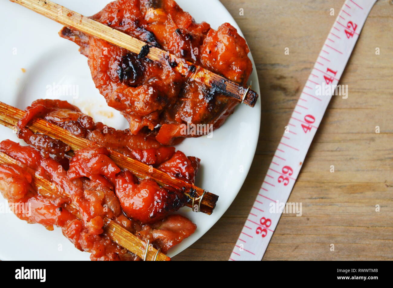 roasted chicken fat skin and measuring tape for check waistline after ...