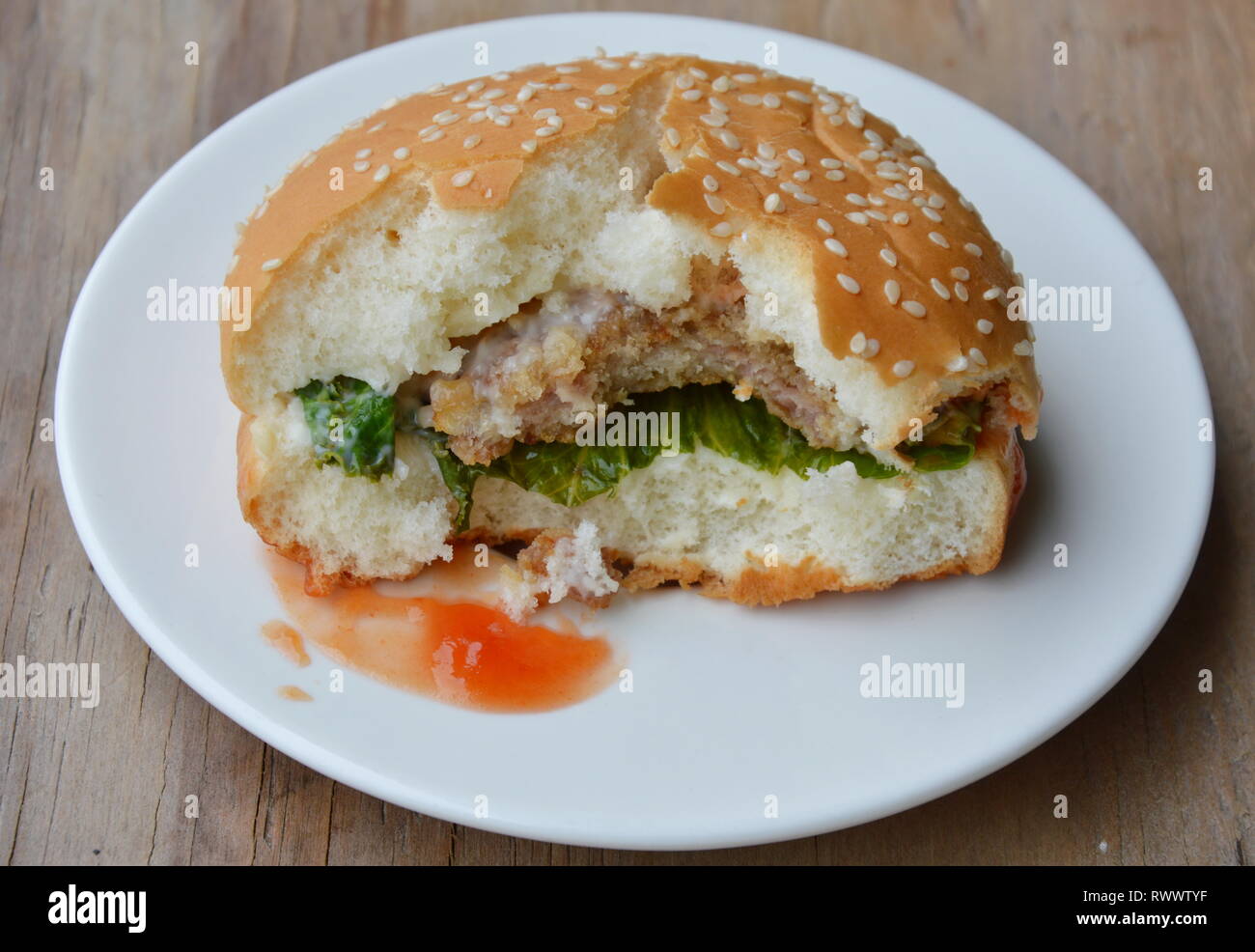 pork hamburger dressing ketchup bite on dish Stock Photo - Alamy