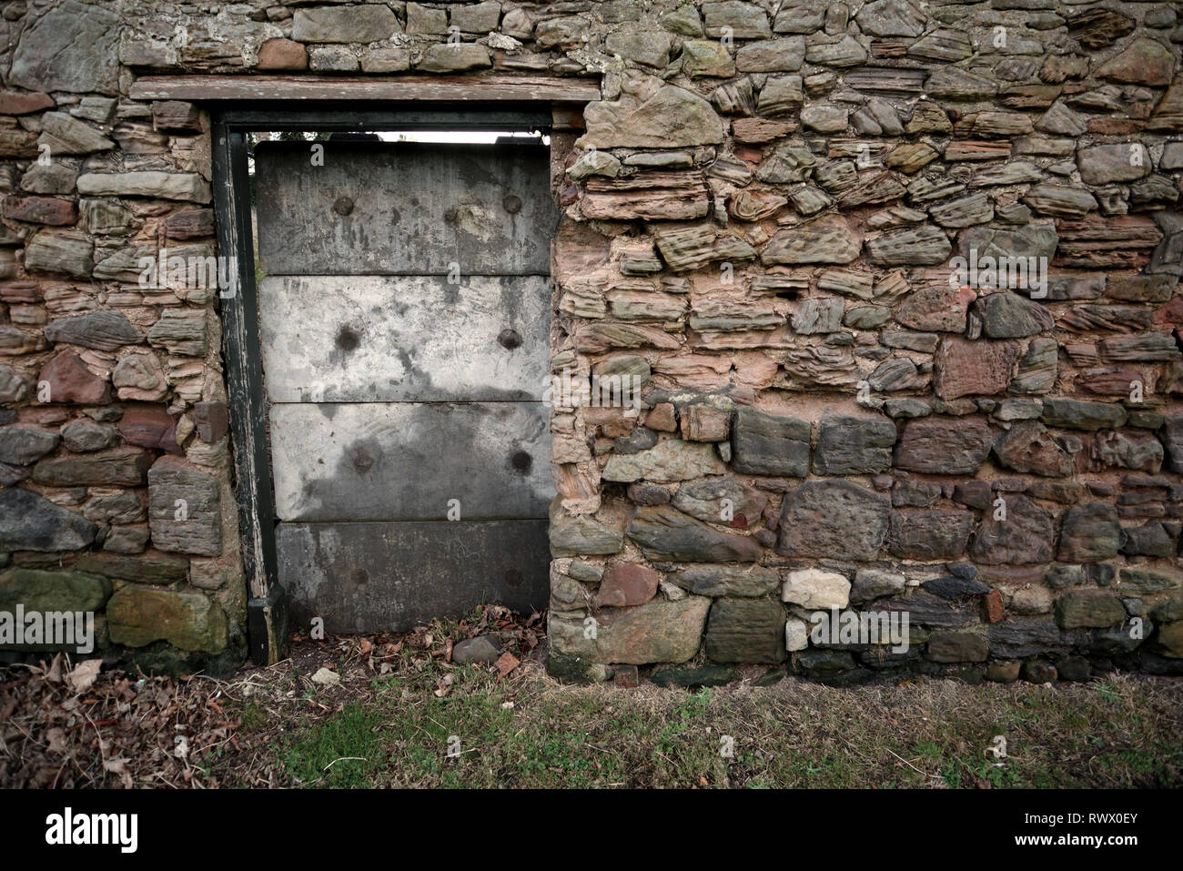 A Creepy old Door in an Old Stone Wall Stock Photo - Alamy