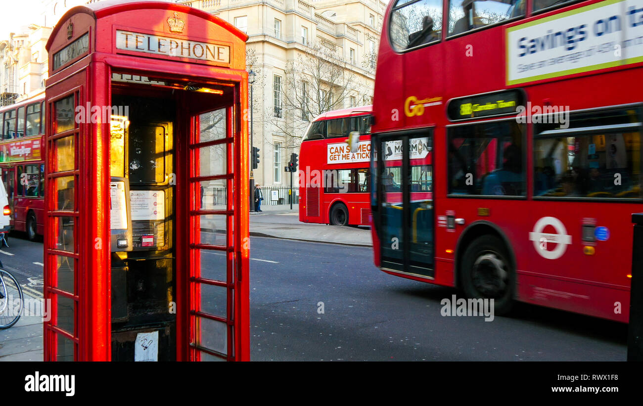 The red telephone booth and the big bus on the street of London Busy ...