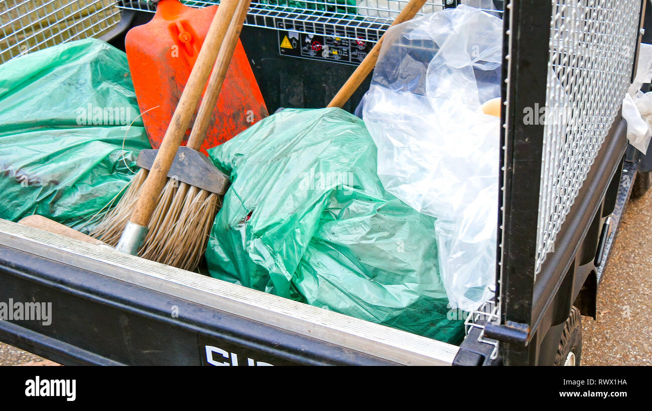 Cleaning tools and garbage collected in the palace. Green bags with ...