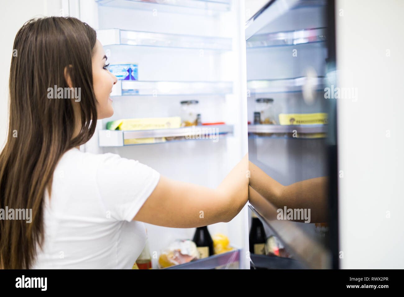 Close-up Of Young Woman Searching For Food In The Fridge Stock Photo ...