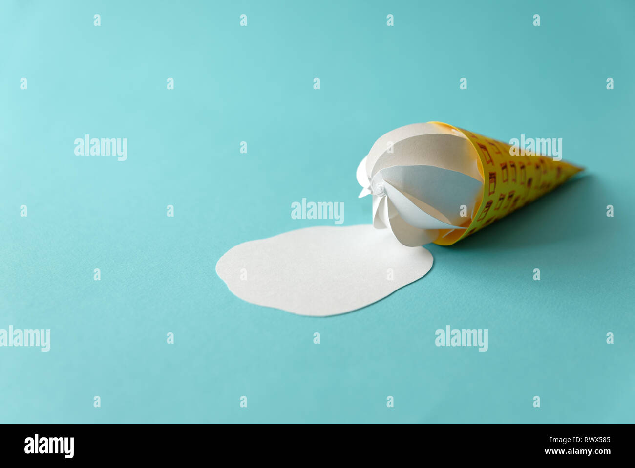 Melted paper vanila ice-cream cone on blue background. Copy space ...