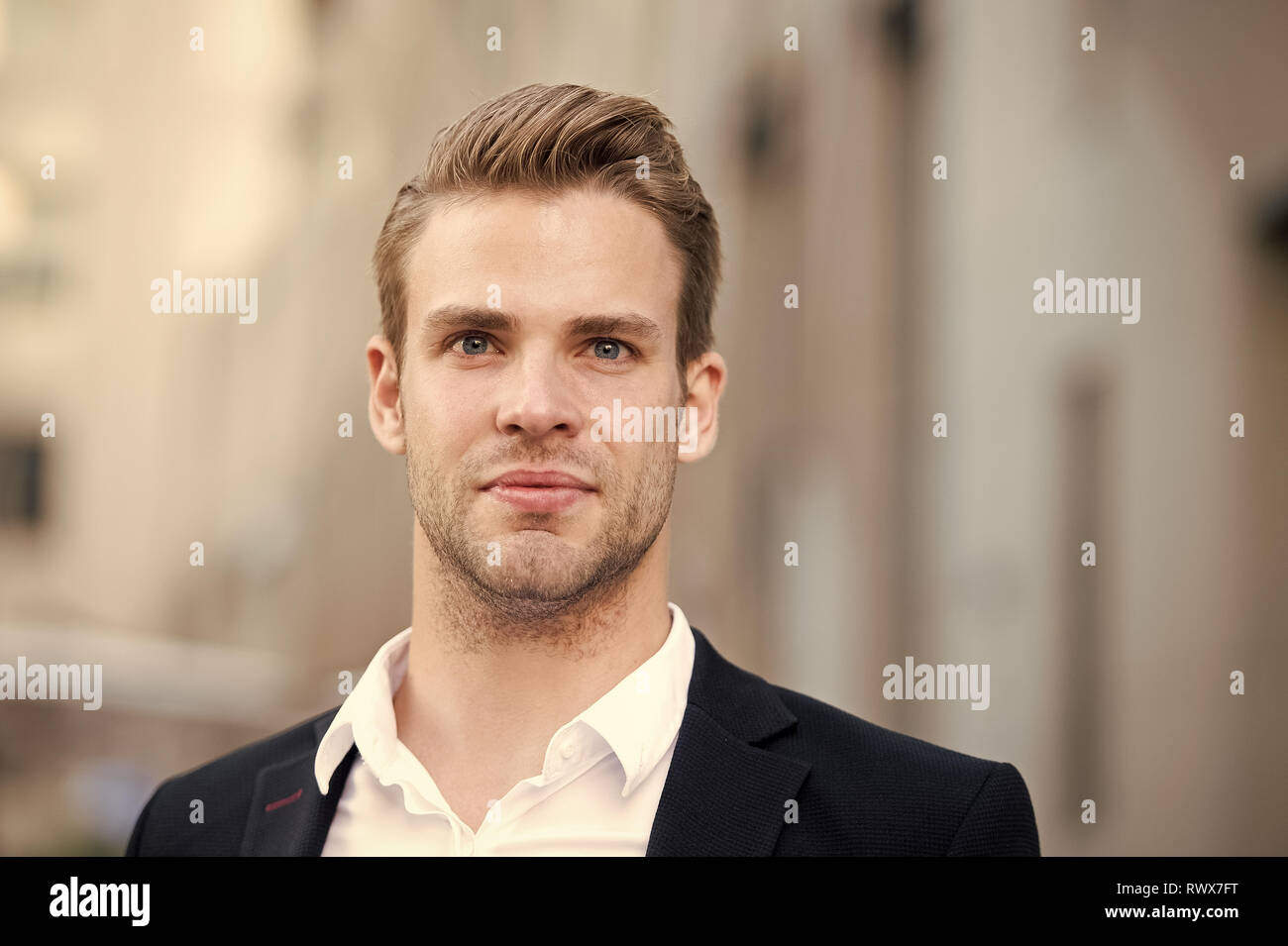 Businessman stand on urban background. Confident man in formal wear ...