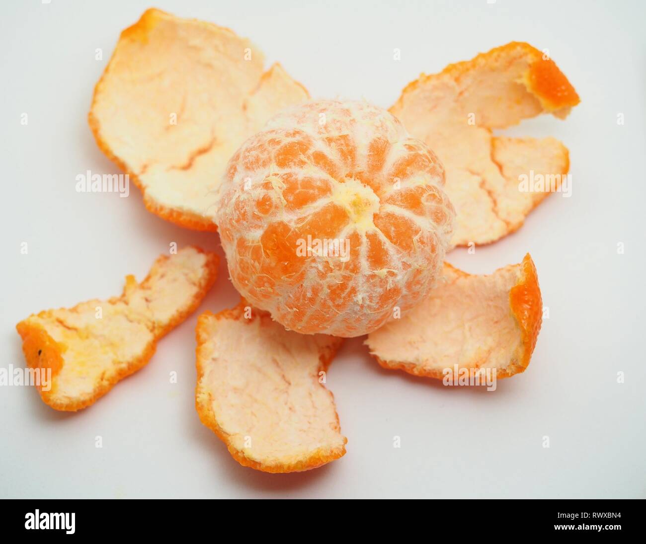 Mandarin is cleared from the skin. Fruit on white background. Still ...