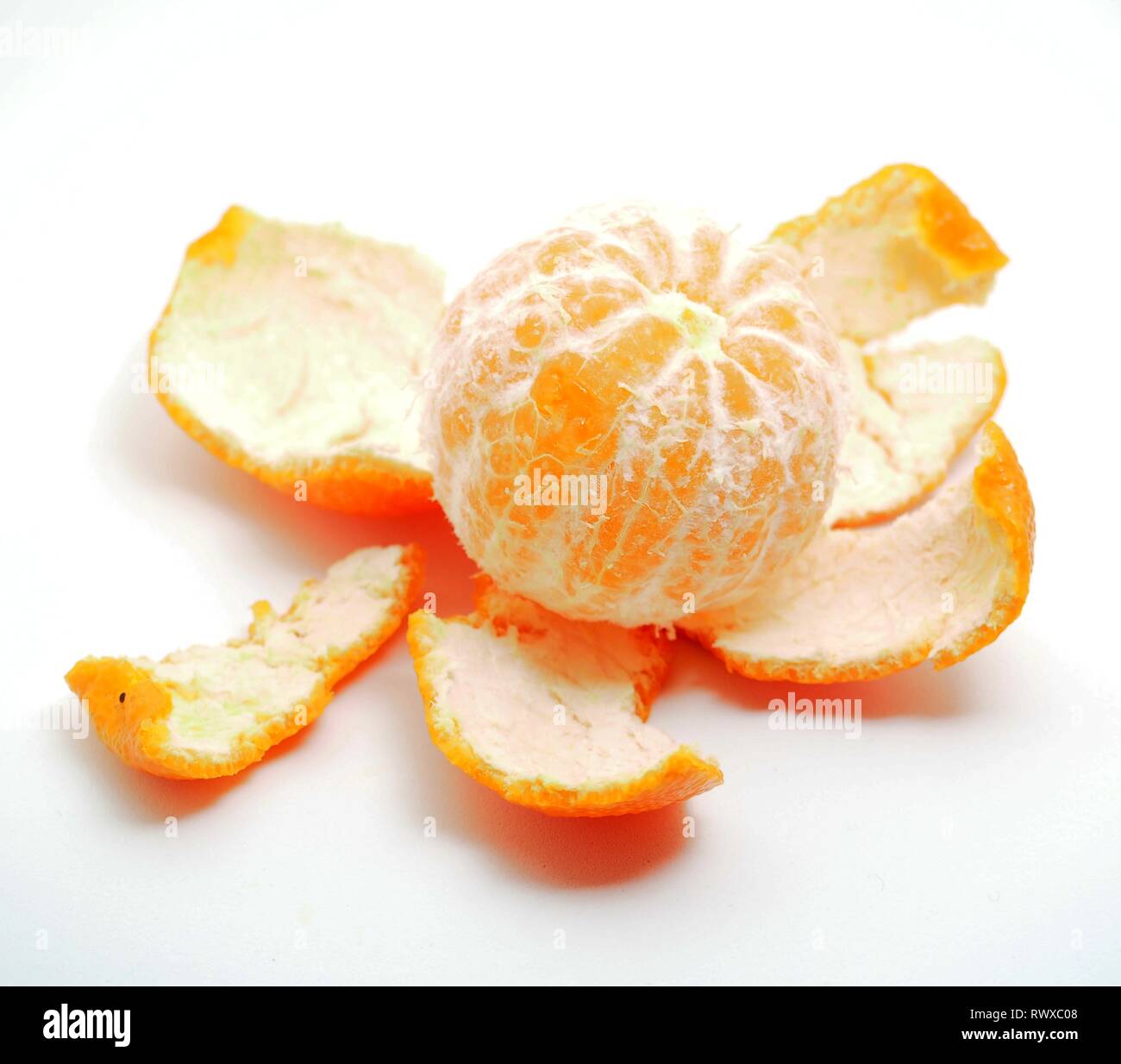 Mandarin is cleared from the skin. Fruit on white background. Still ...