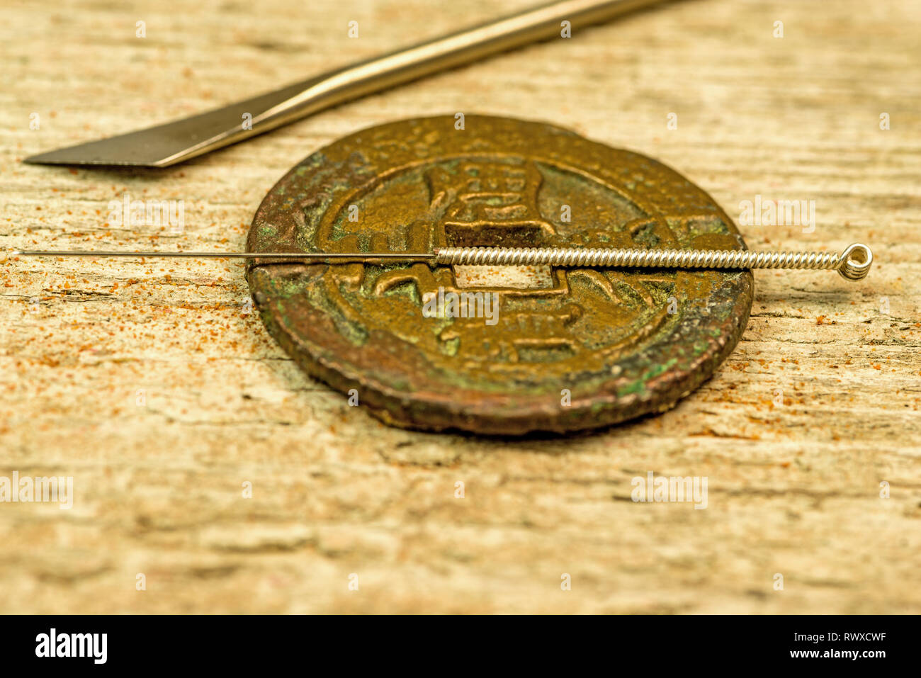 acupuncture needle on antique Chinese coin Stock Photo - Alamy