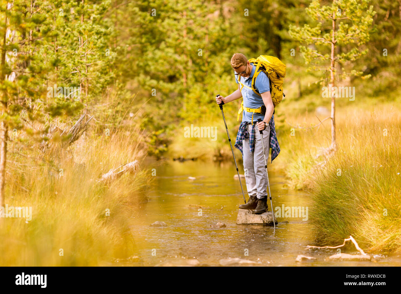 Young man crosses river hi-res stock photography and images - Alamy