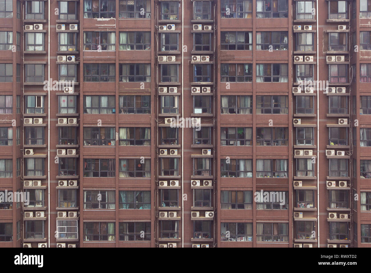 Facade with many apartments in China Stock Photo - Alamy