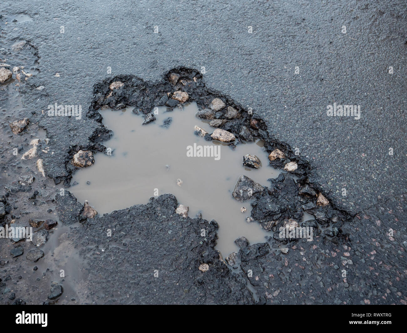 A pothole in road surface. England, UK Stock Photo - Alamy