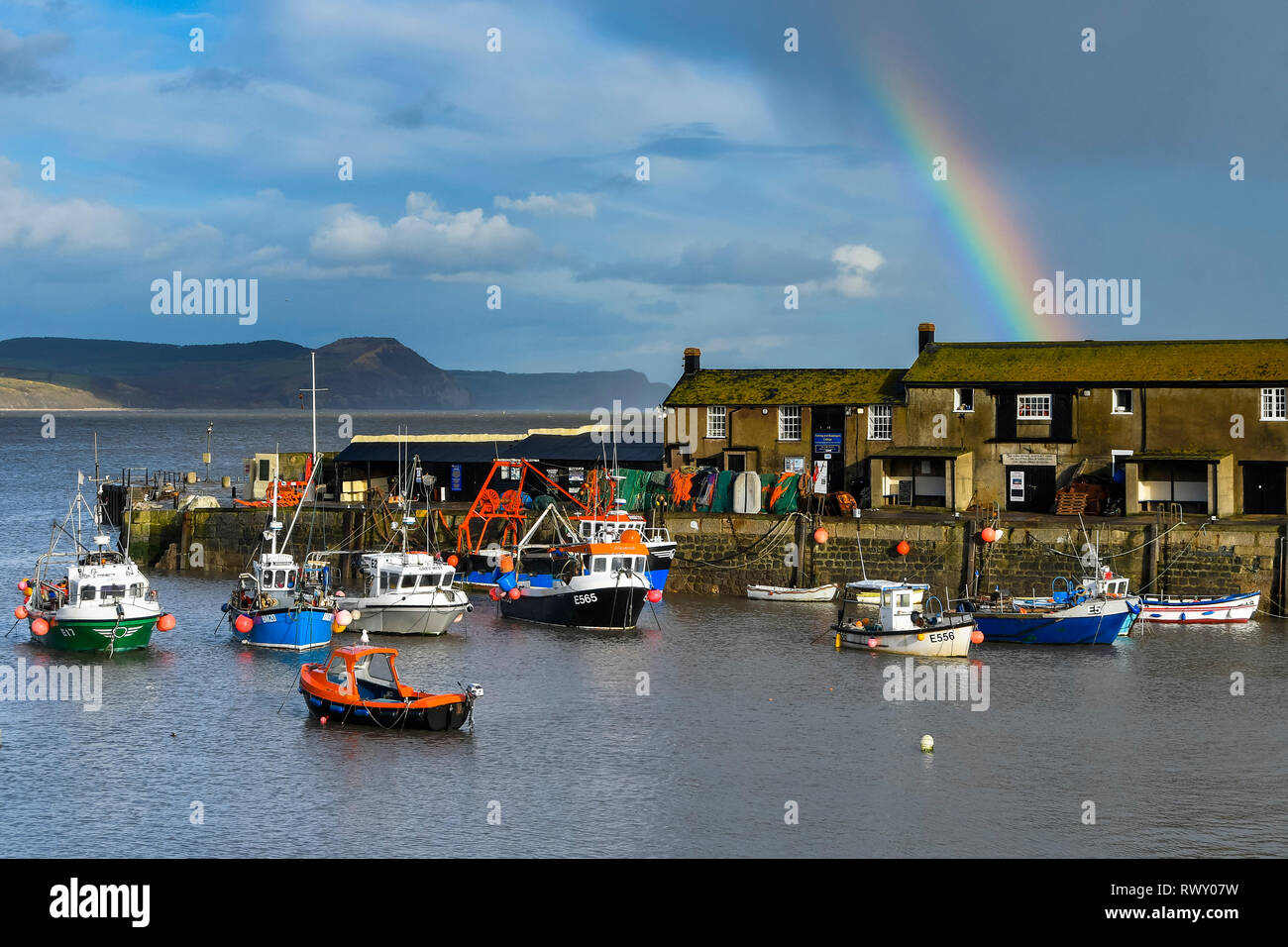 Lyme Regis, Dorset, UK. 7th March 2019. UK Weather. A rainbow arches ...