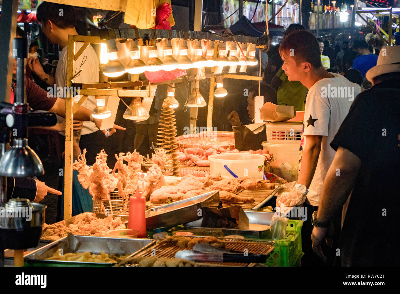fried and BBQ meat seller and customer stall at Jalan Alor food street ...