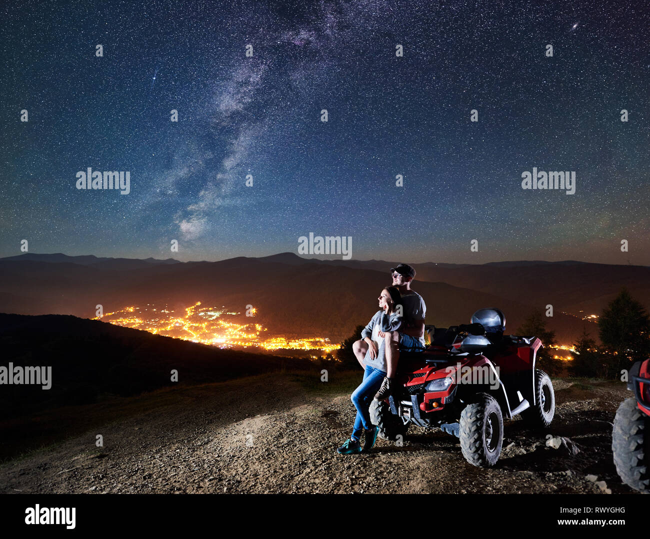 Active man and woman trevelers with atv quad motorbike on the top of ...