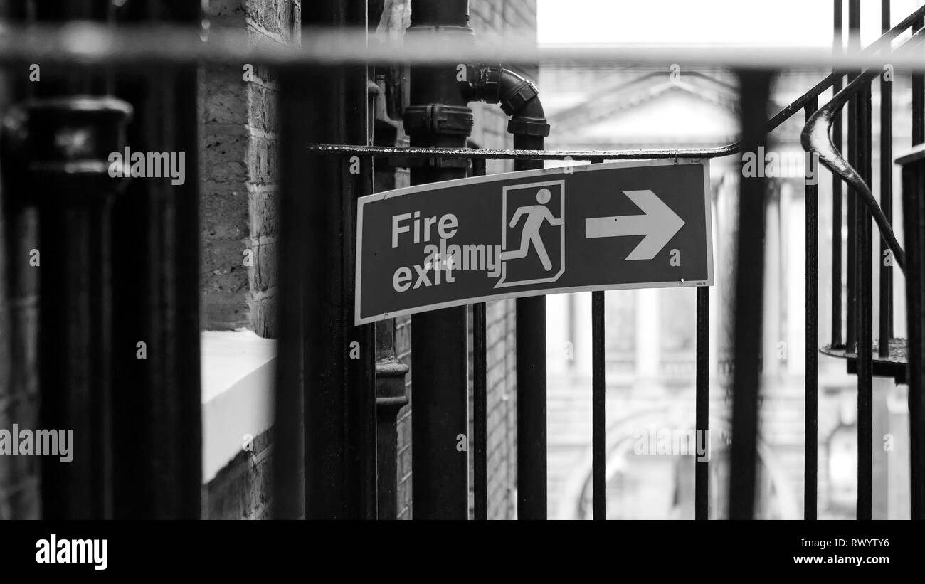 Green fire escape direction sign Black and White Stock Photos & Images ...