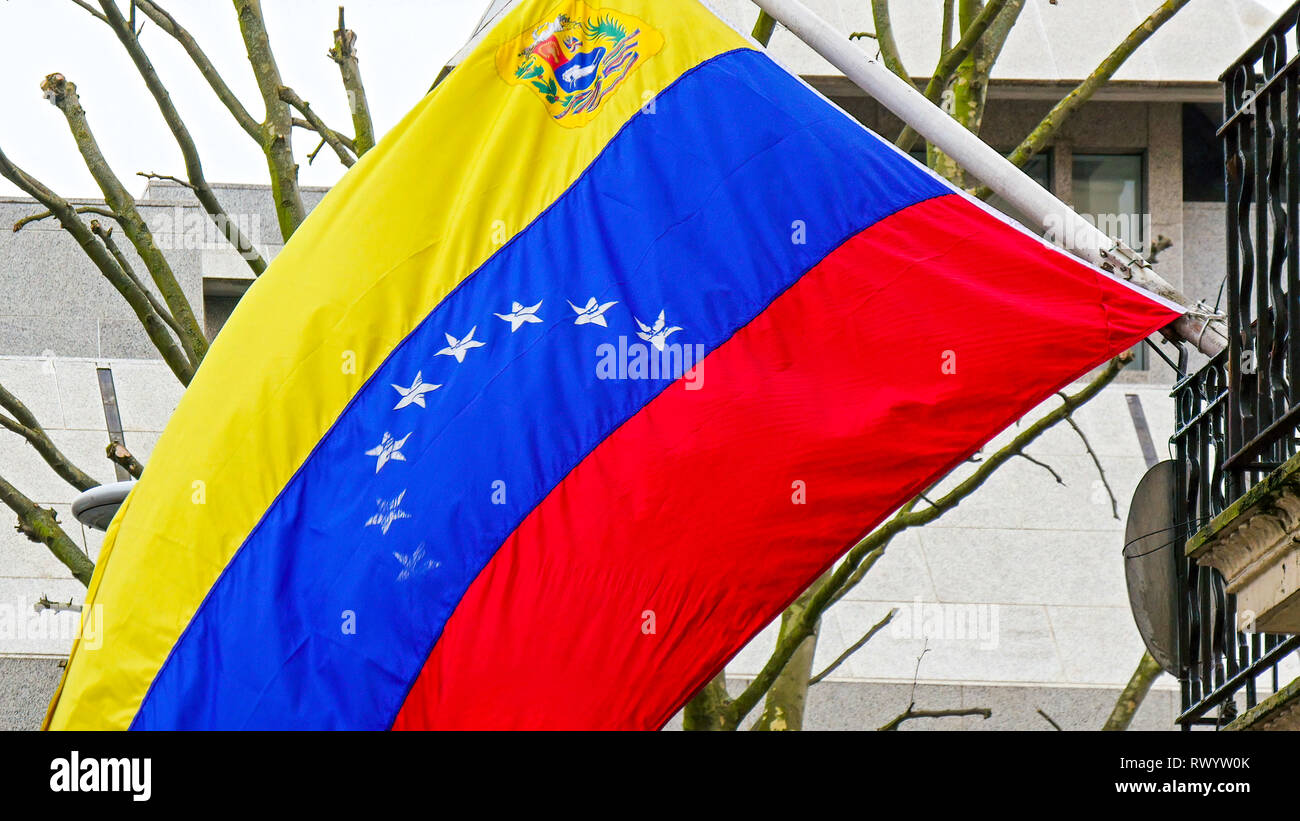 A Venezuelan flag waving on the pole in the terrace of a building ...