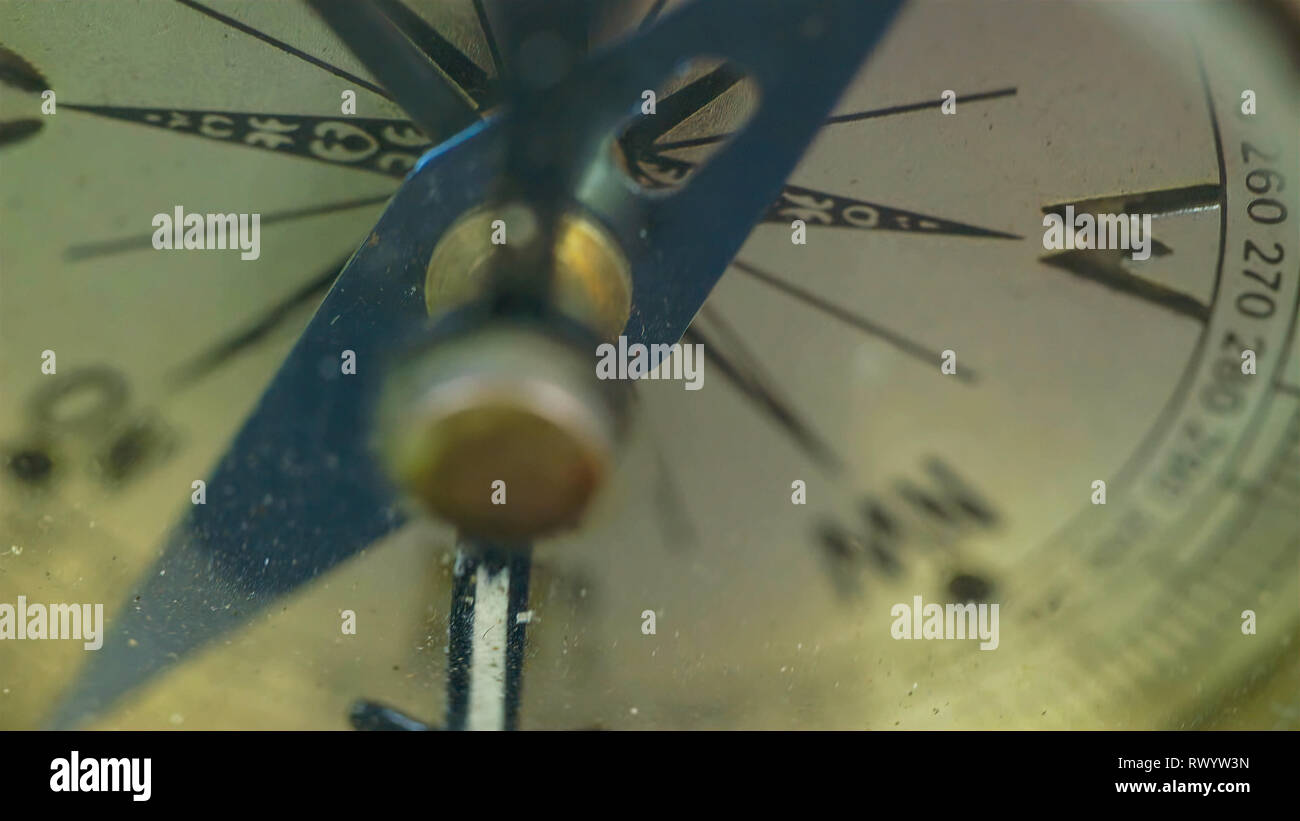 The tip of an old and rusty compass. The small compass determines the ...