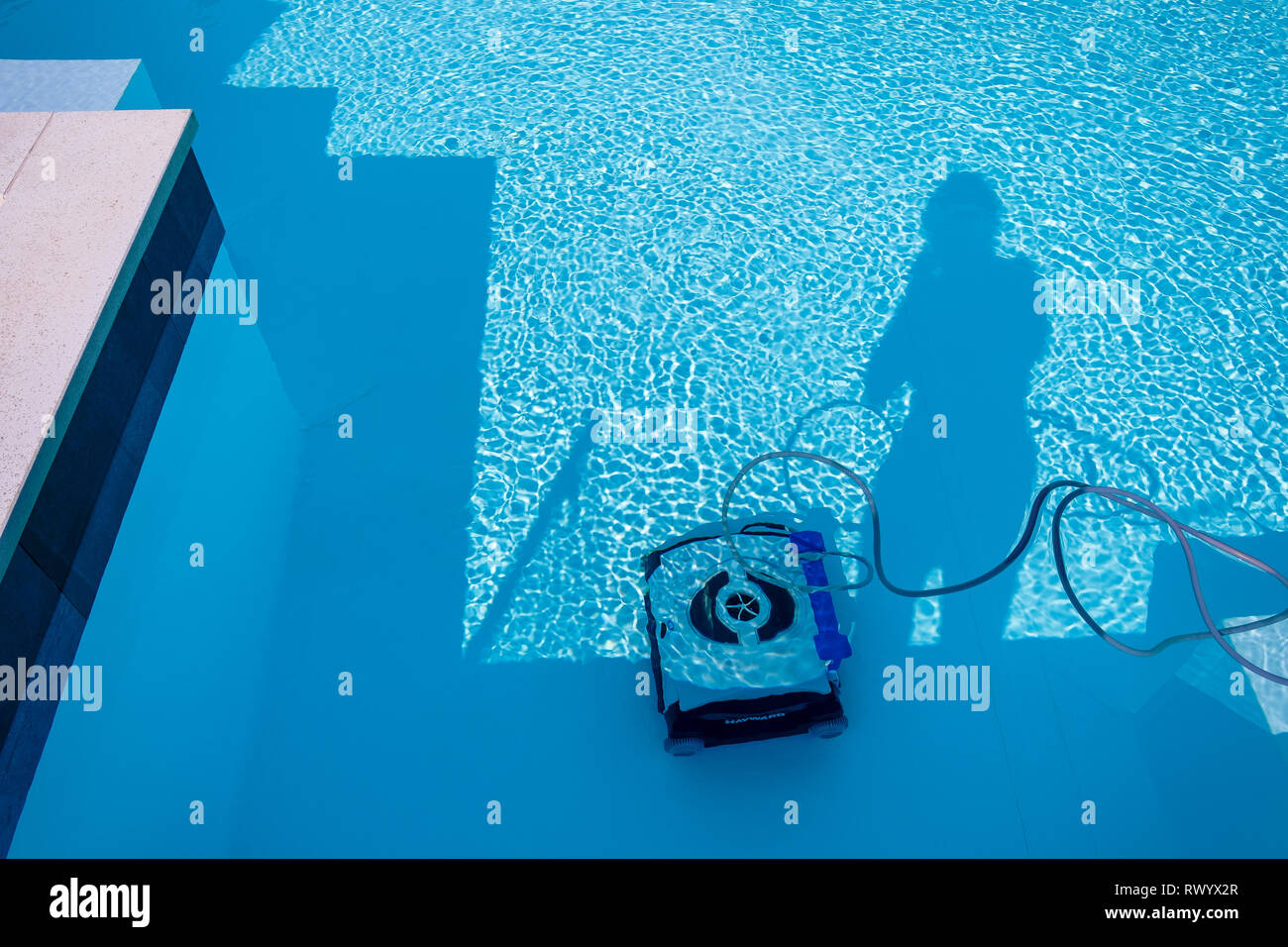 Swimming pool in the italian resort Lido.Robot cleaner and silhouette ...
