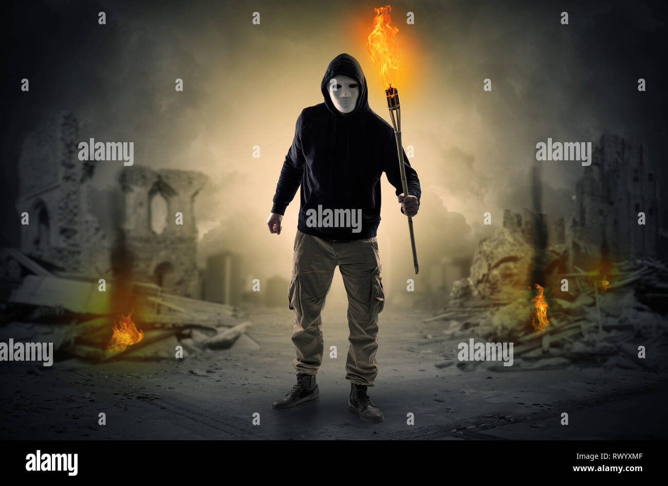 Destroyed place after a catastrophe with man and burning flambeau ...