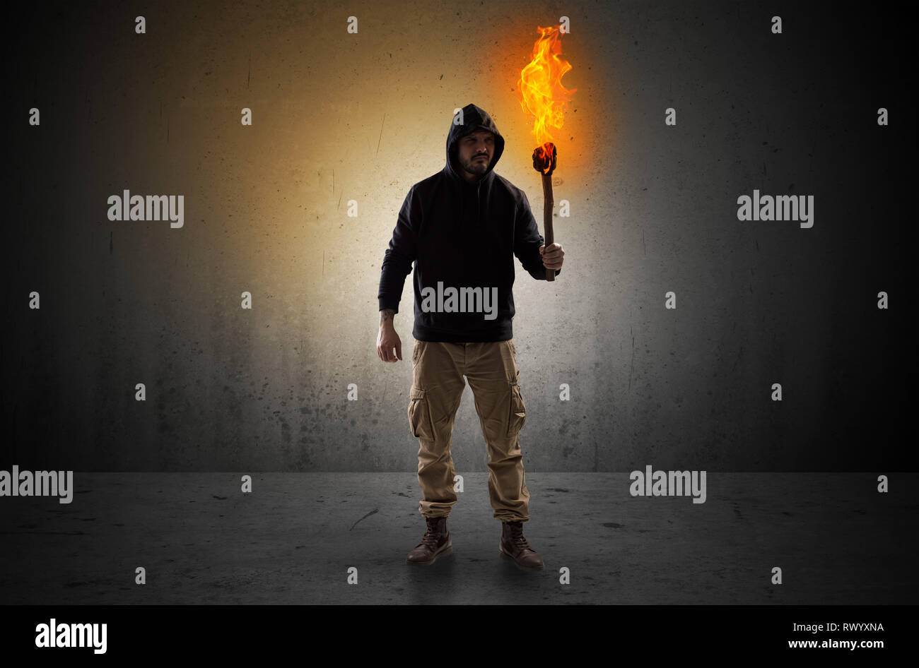 Ugly scary man with burning flambeau walking in an empty space Stock ...