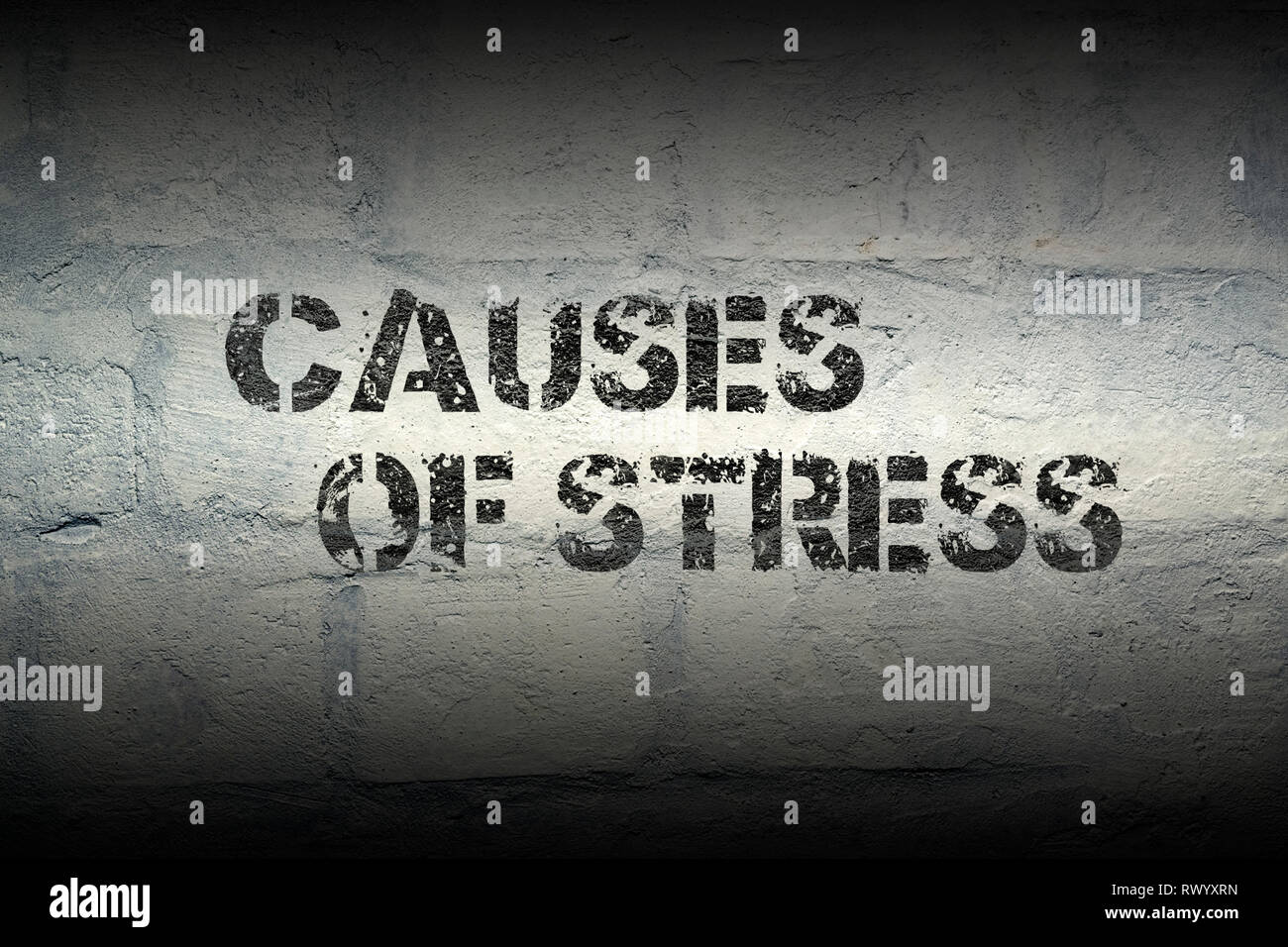 causes of stress stencil print on the grunge white brick wall Stock ...