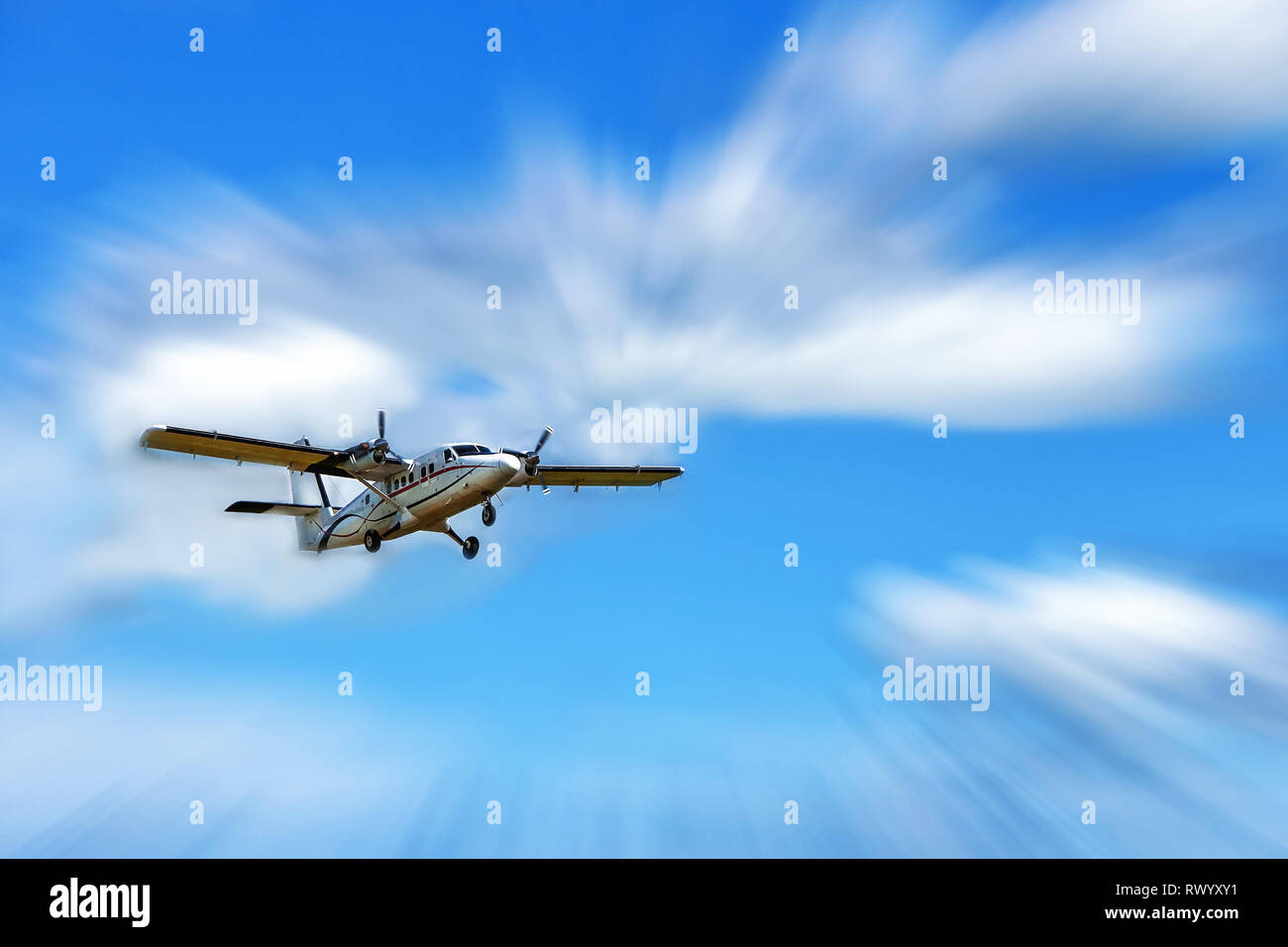 Flying small passenger propeller aircraft on the background of blue ...
