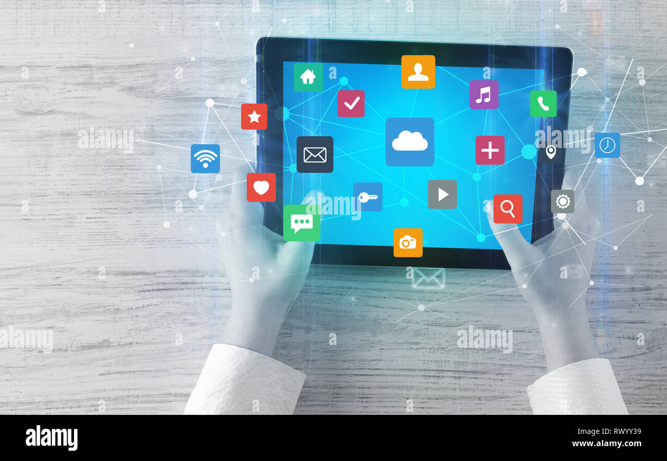Hand touching multitask tablet with cloud wifi message social media ...