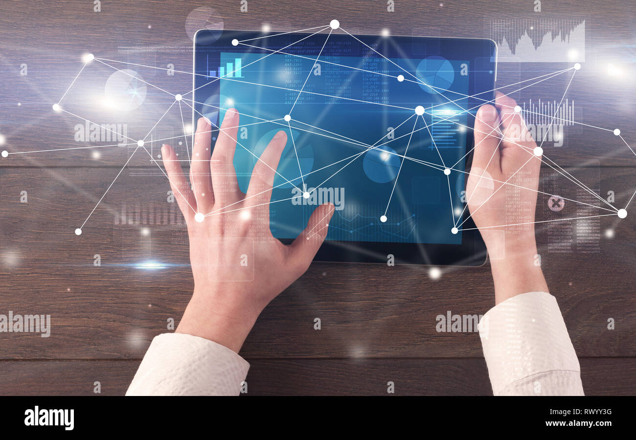 Hand using tablet with linking graphs charts report and informational ...