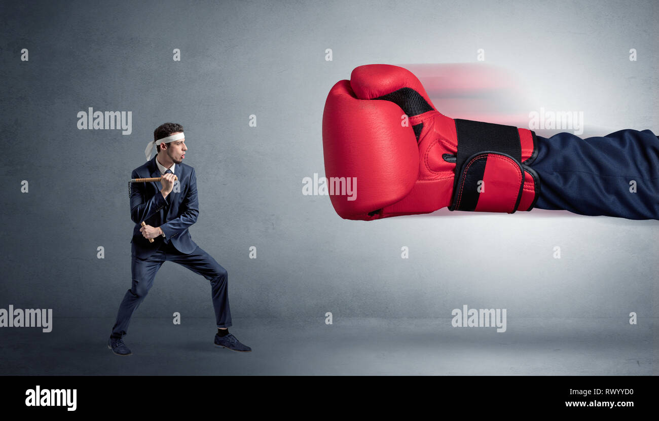 Little man fighting with a giant red boxing glove Stock Photo - Alamy