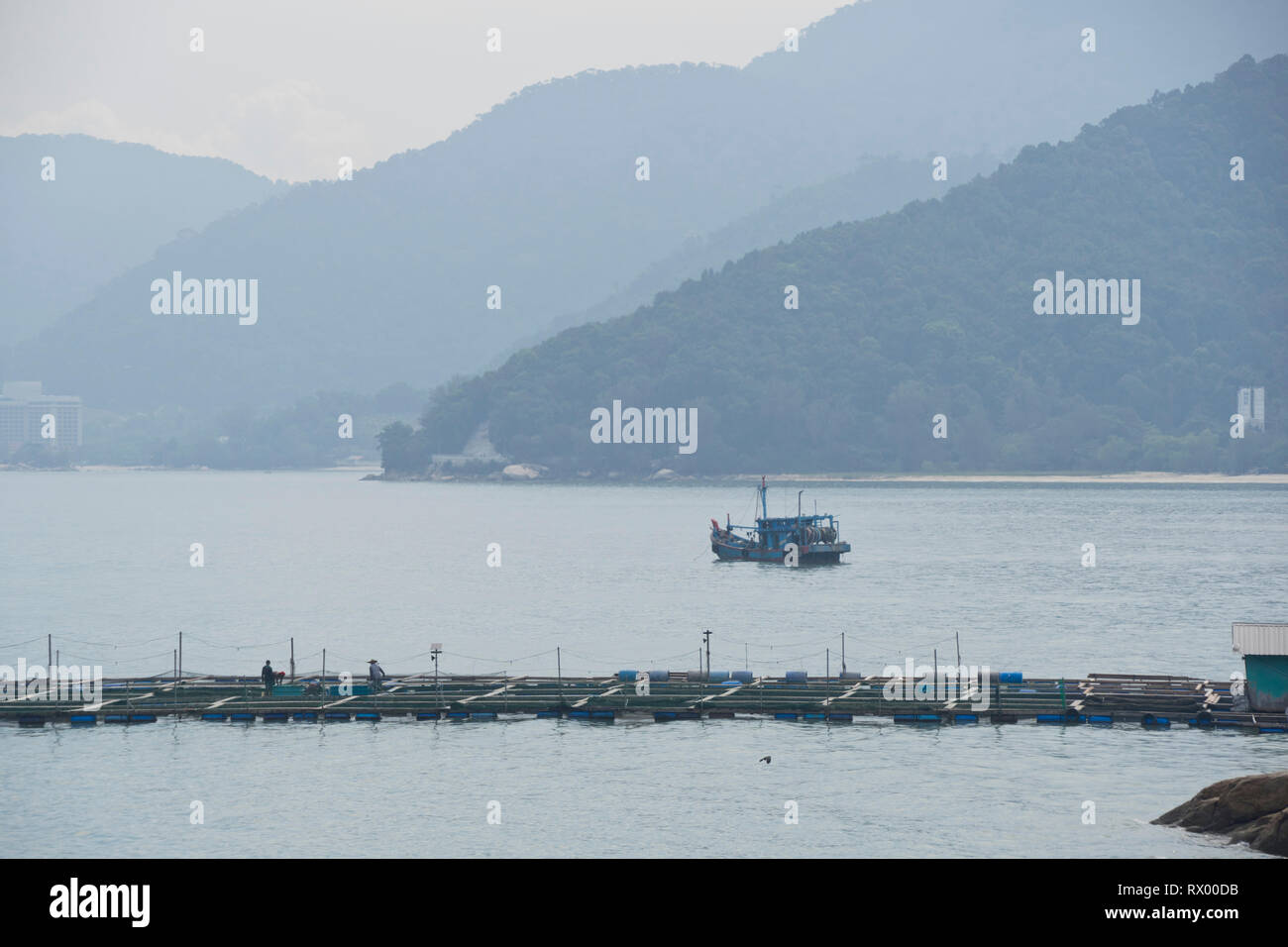 Fishing village and boats on pier by the rainforest in the Taman Negara ...