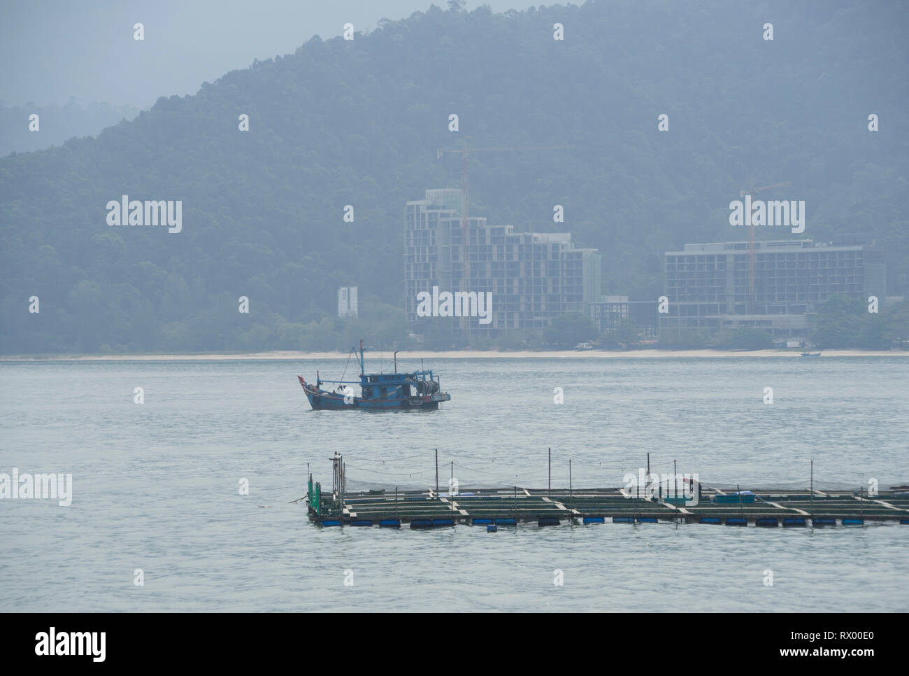 Fishing village and boats on pier by the rainforest in the Taman Negara ...