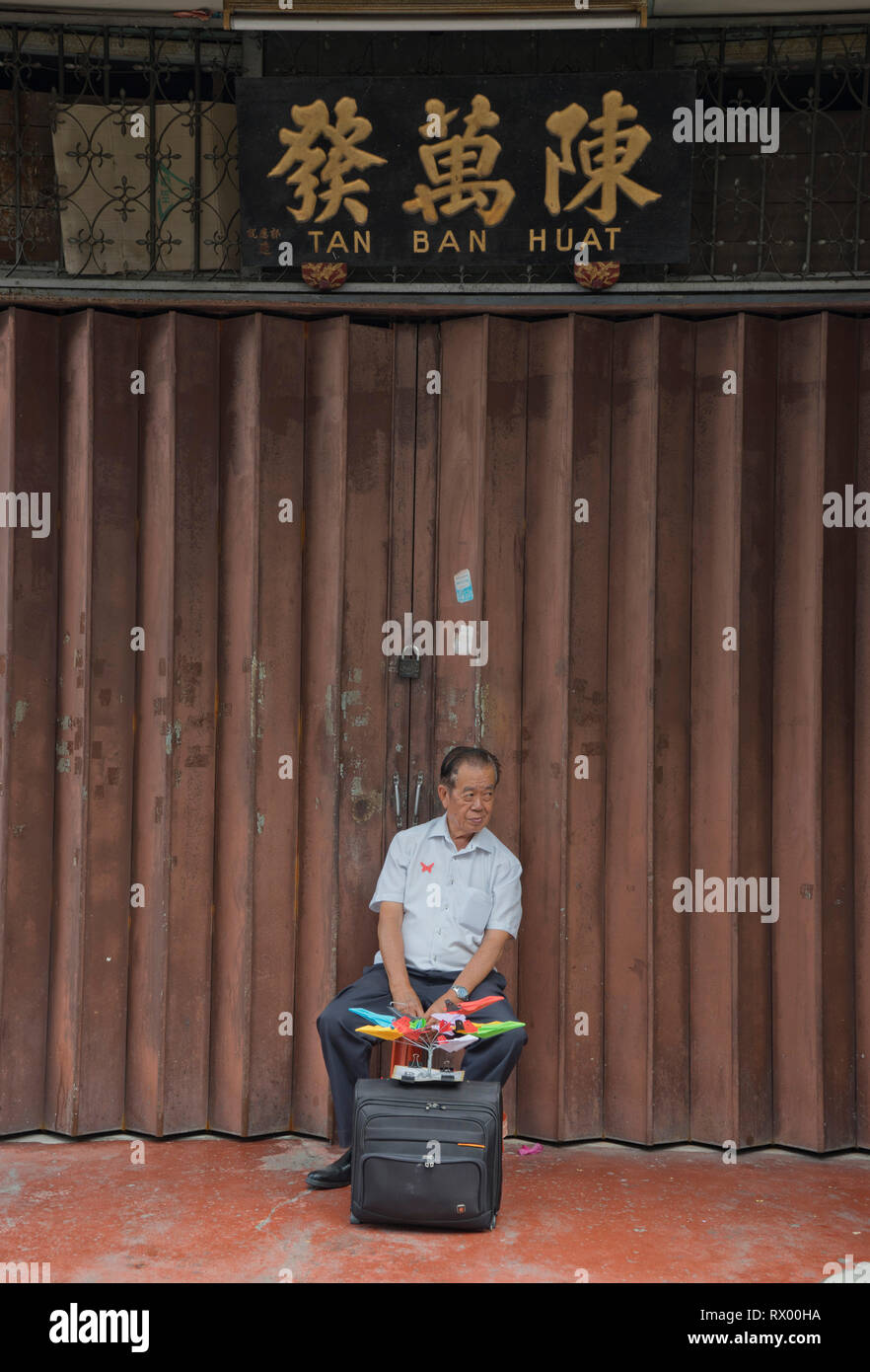 Chinese man selling trinkets in Chinatown, George Town,Penang,Malaysia ...