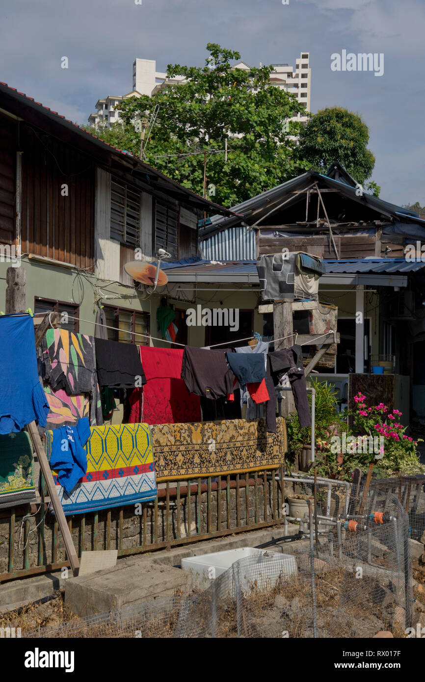 Old traditional kampong houses in neighbourhood with high rise ...