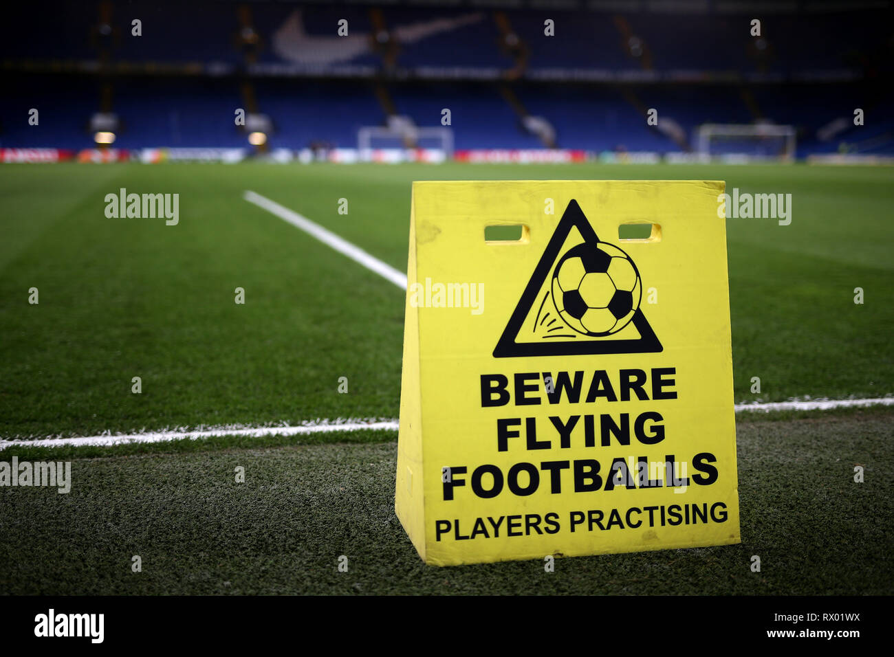 A detail view of a 'Beware Flying Footballs Players Practising' sign ...
