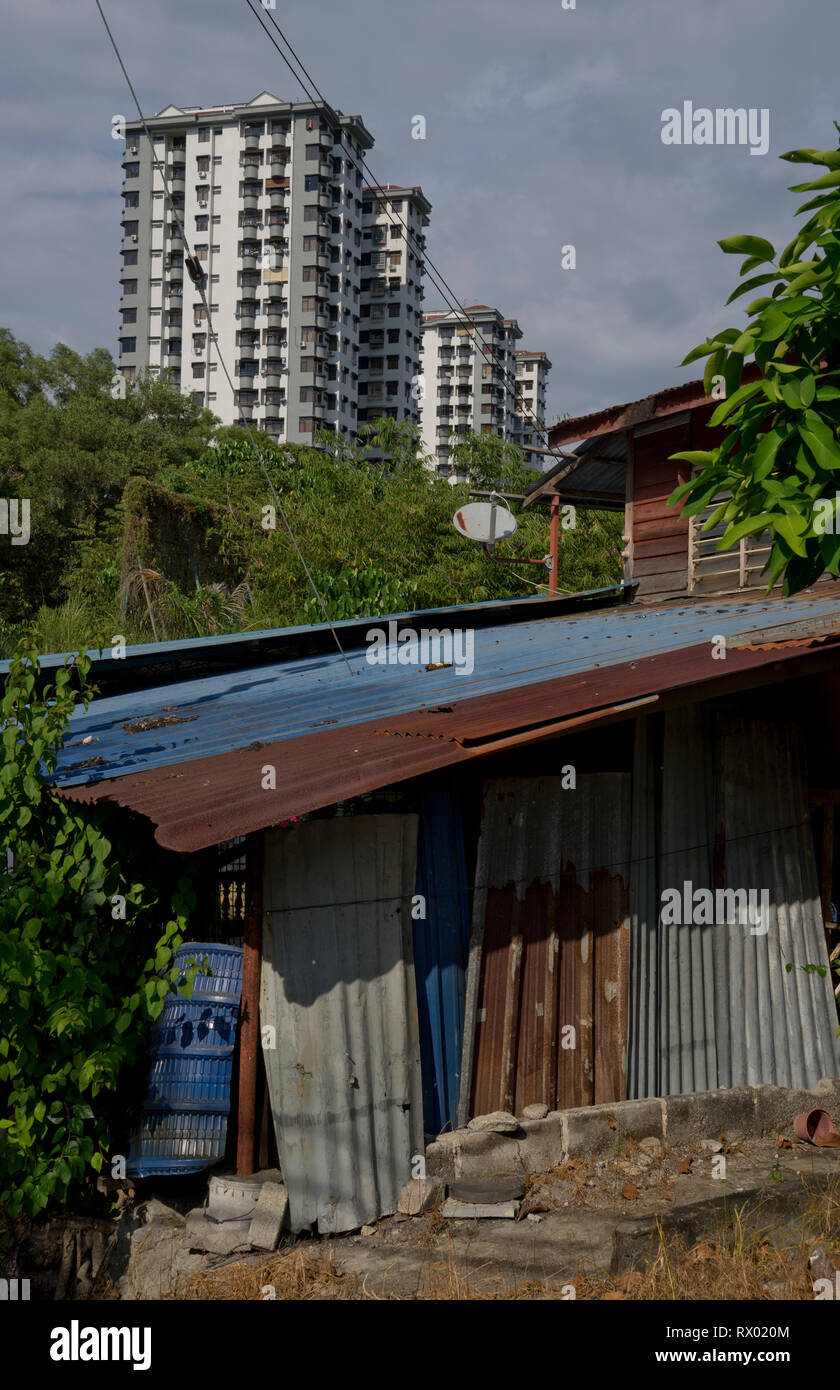 Old traditional kampong houses in neighbourhood with high rise ...