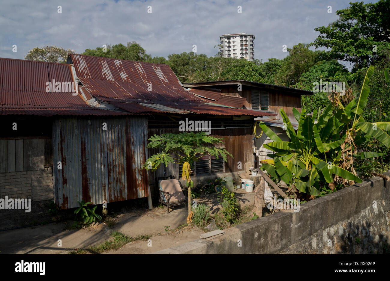 Old traditional kampong houses in neighbourhood with high rise ...