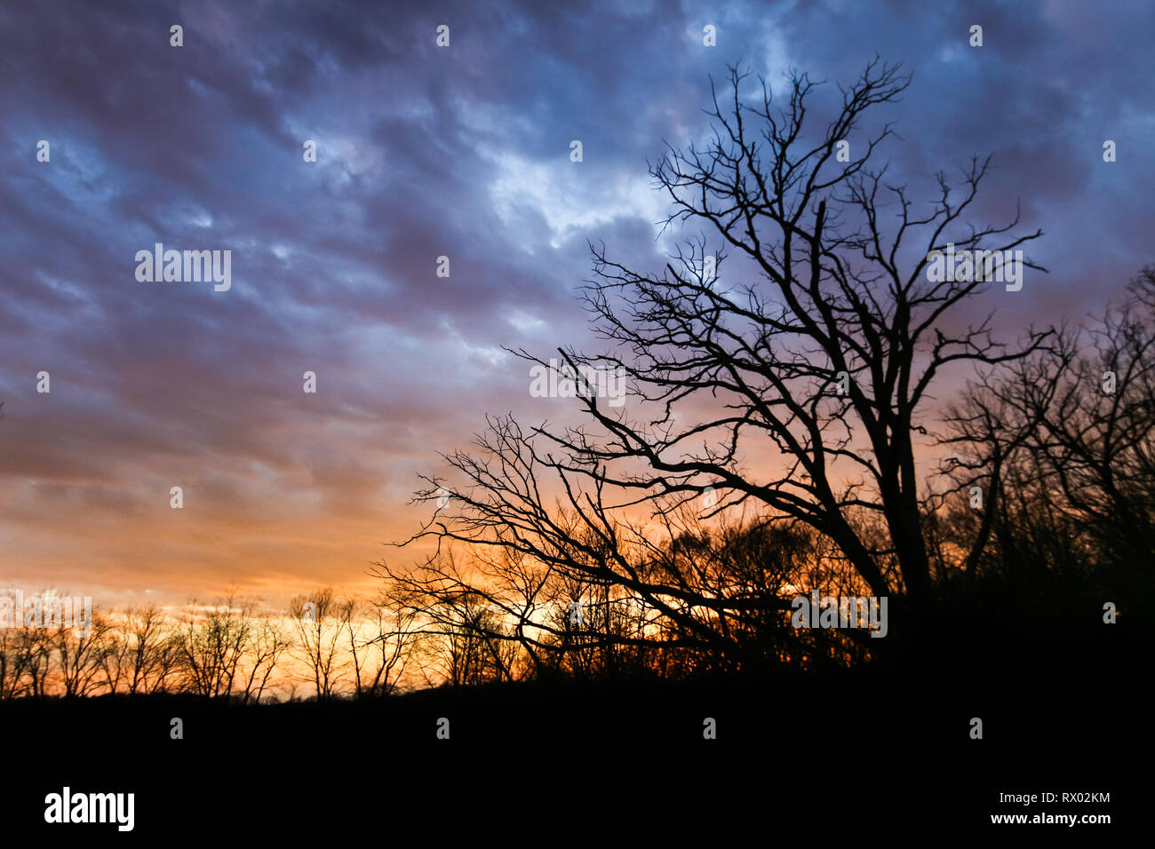 stunning sunset with sunlight bouncing off clouds Stock Photo - Alamy