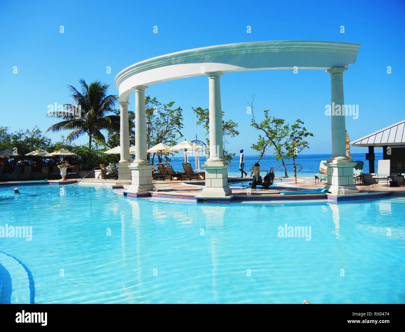 marble structure near a pool on a tropical resort Stock Photo - Alamy