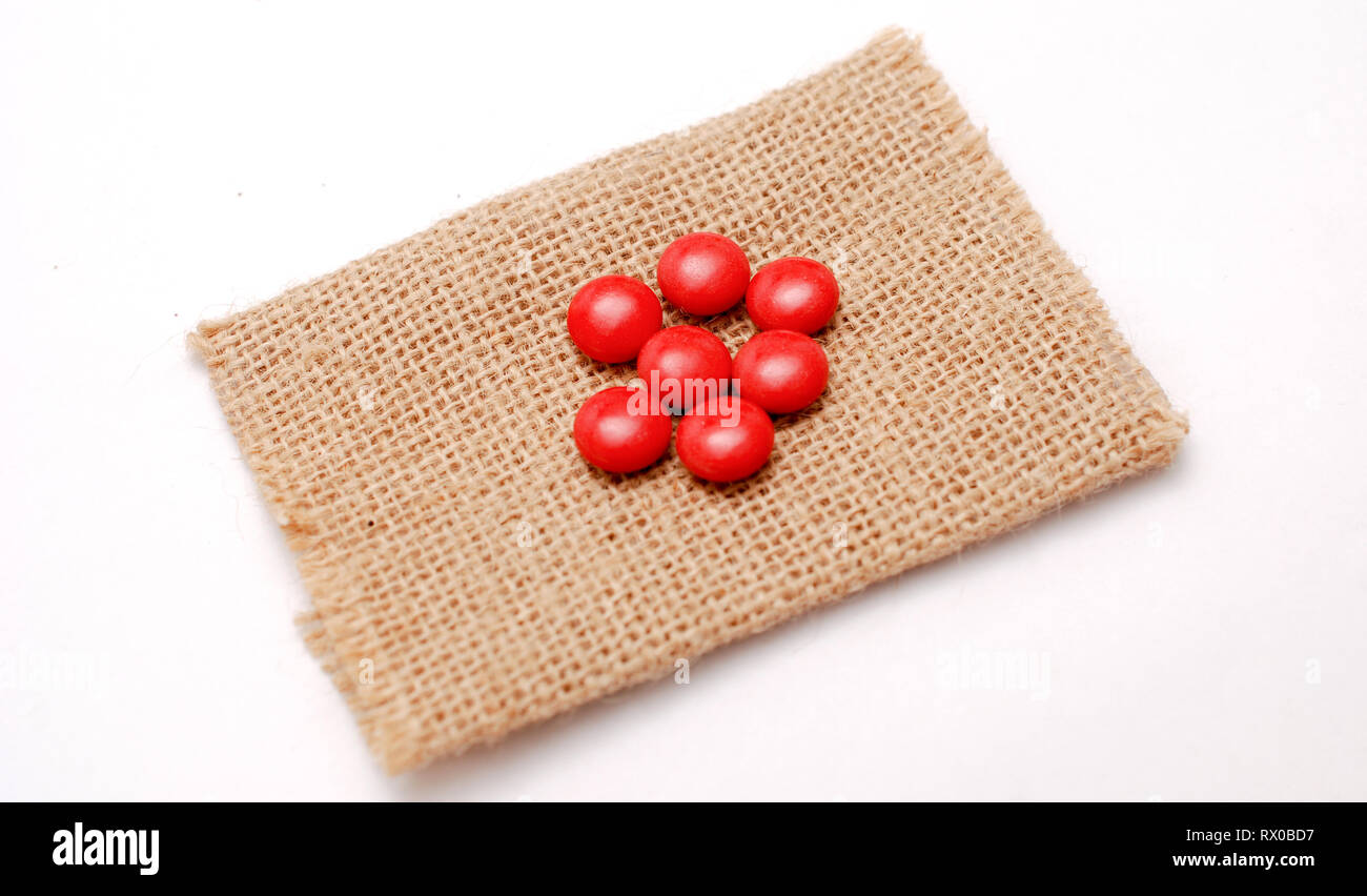multivitamin red pills on a jute bag background, image Stock Photo - Alamy